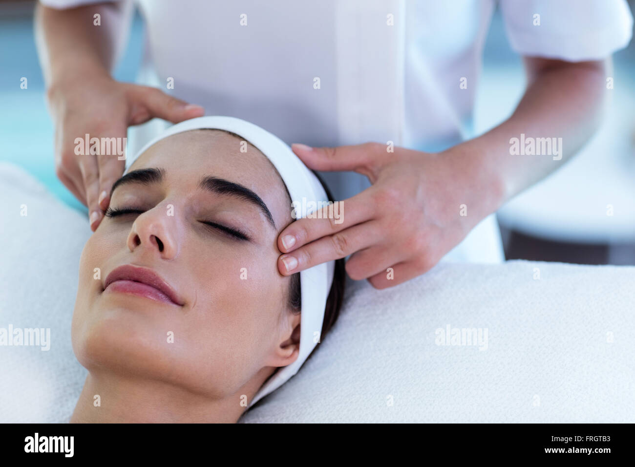 Woman receiving a temple massage Stock Photo - Alamy