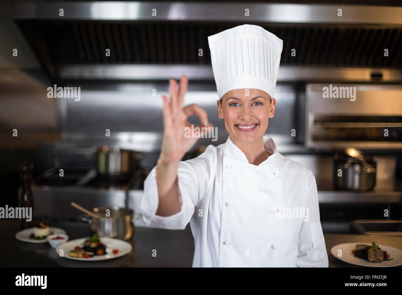 Portrait of smiling female chef showing ok sign Stock Photo - Alamy