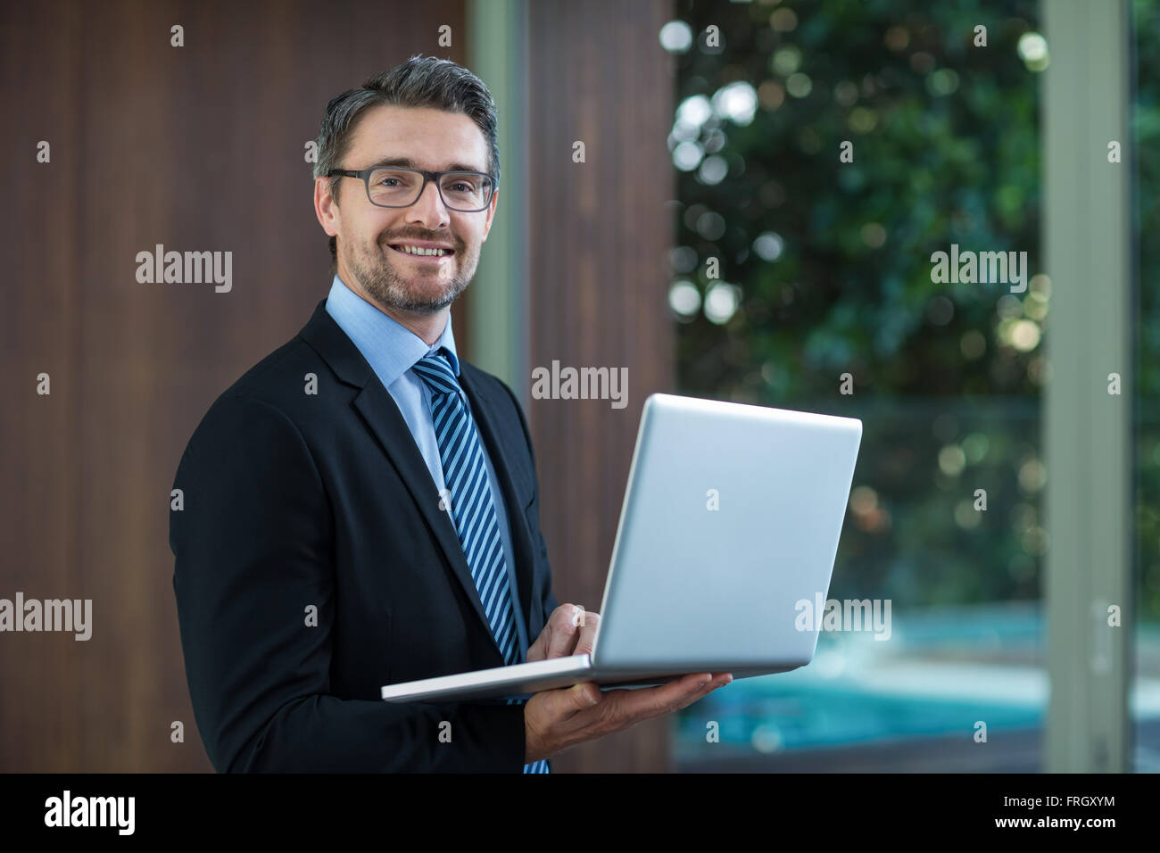 Businessman using laptop Stock Photo - Alamy