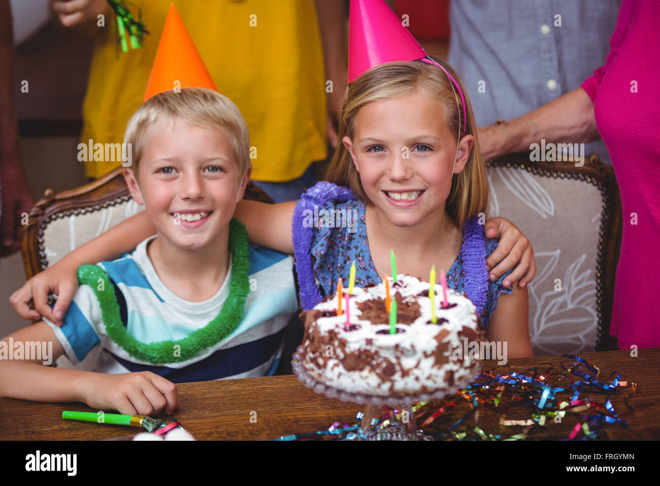 Smiling siblings with birthday cake Stock Photo - Alamy