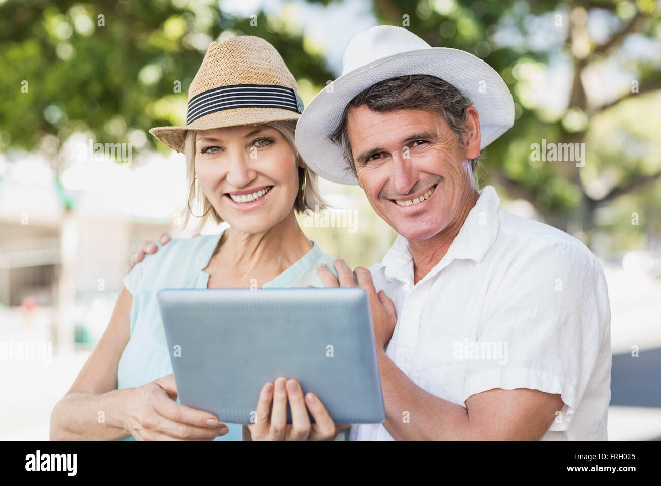 Portrait of couple using digital tablet Stock Photo - Alamy