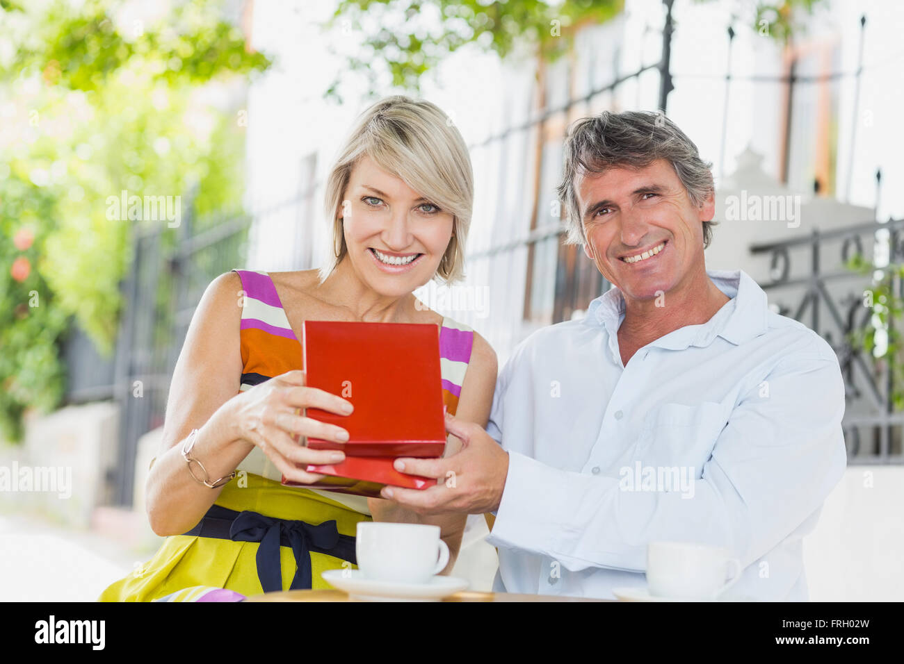 Portrait of couple with present Stock Photo - Alamy
