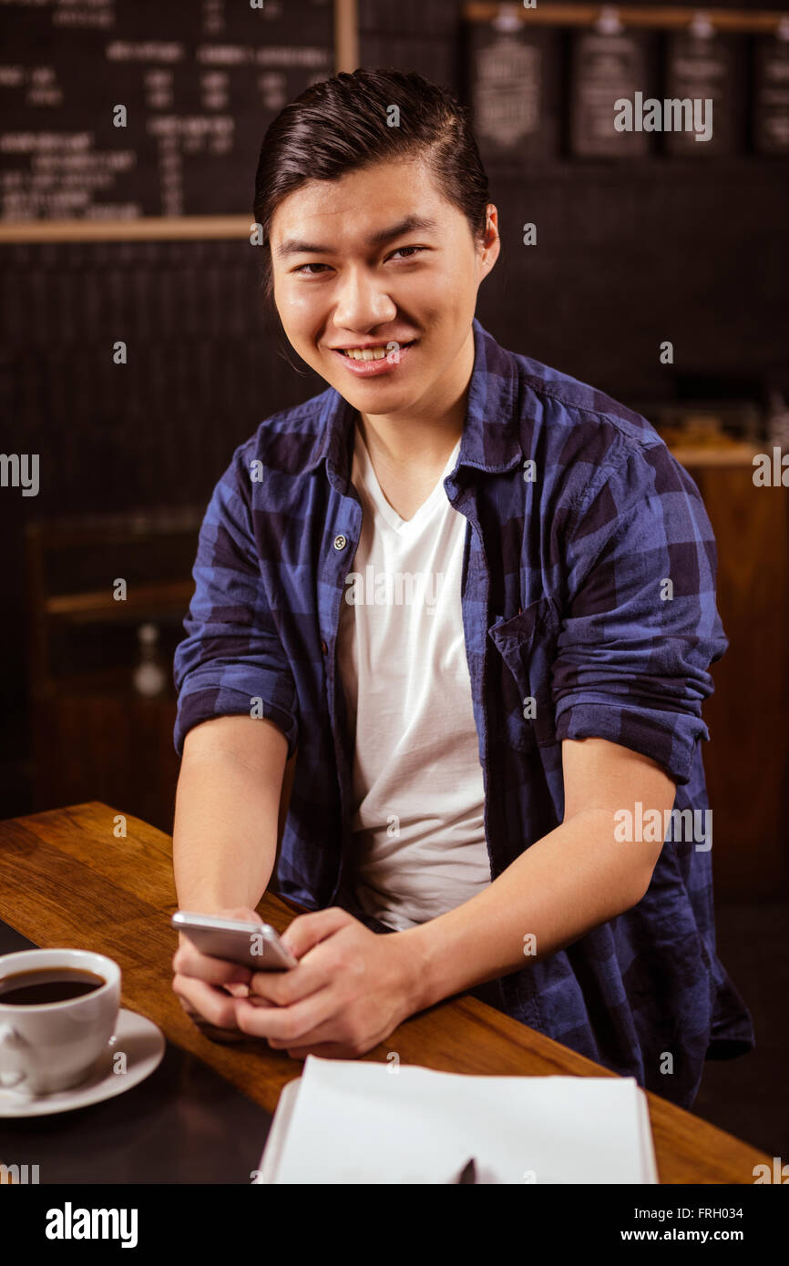 Man using his smartphone Stock Photo - Alamy