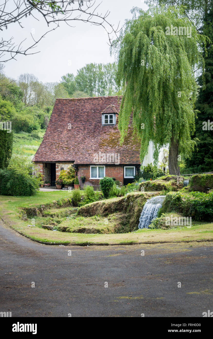 Old cottage with waterfall in the garden, in the pretty village of ...