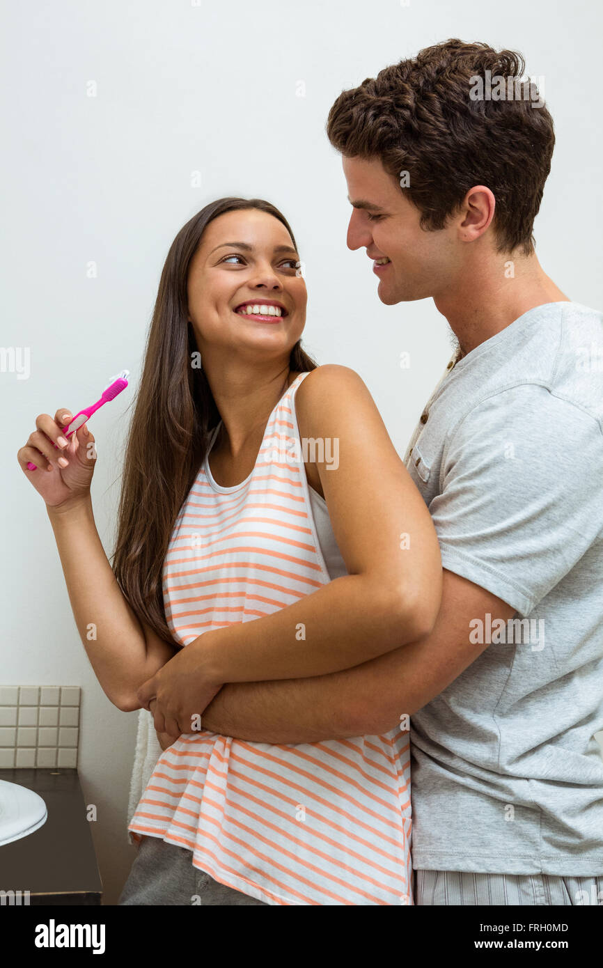 Couple hugging while brushing teeth Stock Photo - Alamy