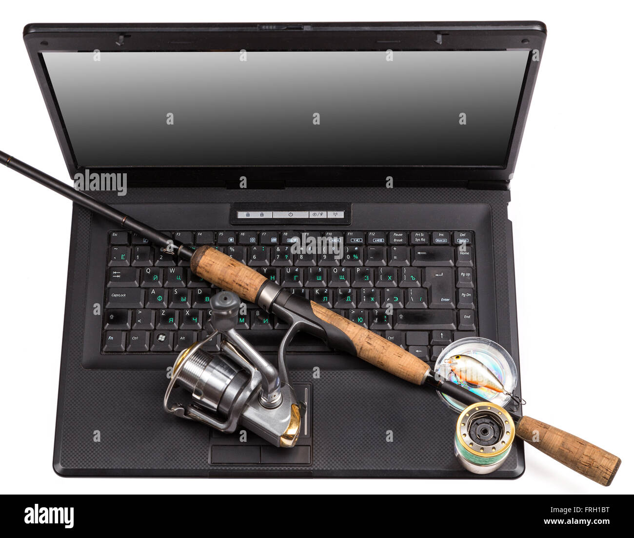 different fishing tackles on dark keyboard a black notebook. Concept ...