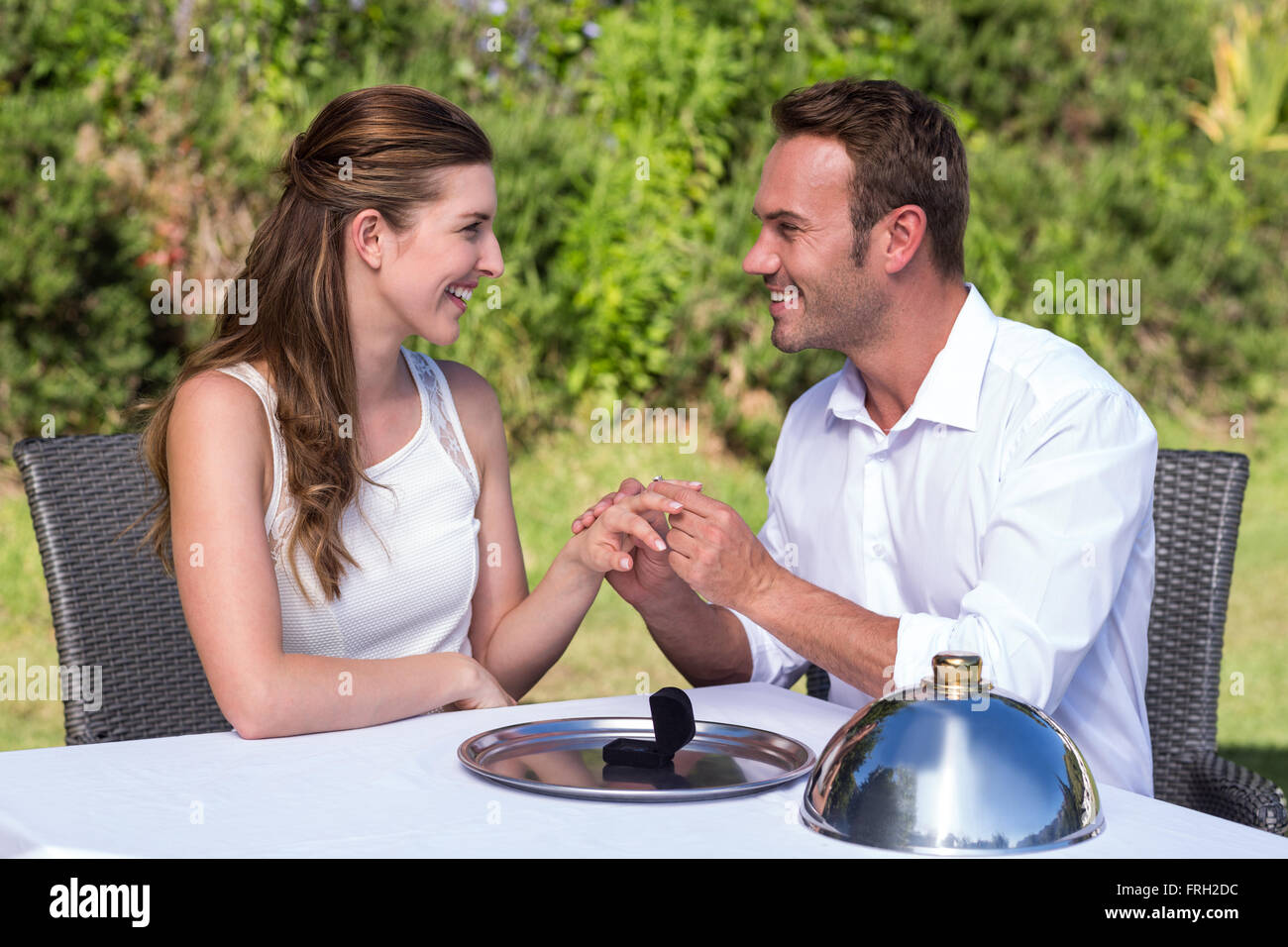 Smiling man proposing woman at park Stock Photo - Alamy