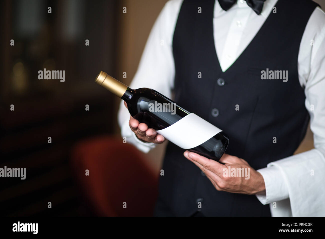 Waiter presenting red wine Stock Photo - Alamy