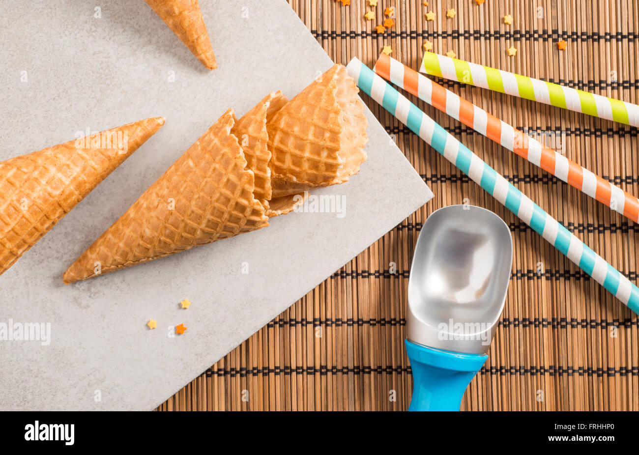 Colorful sugar sprinkles, straws and ice cream cones. Preparation for ...
