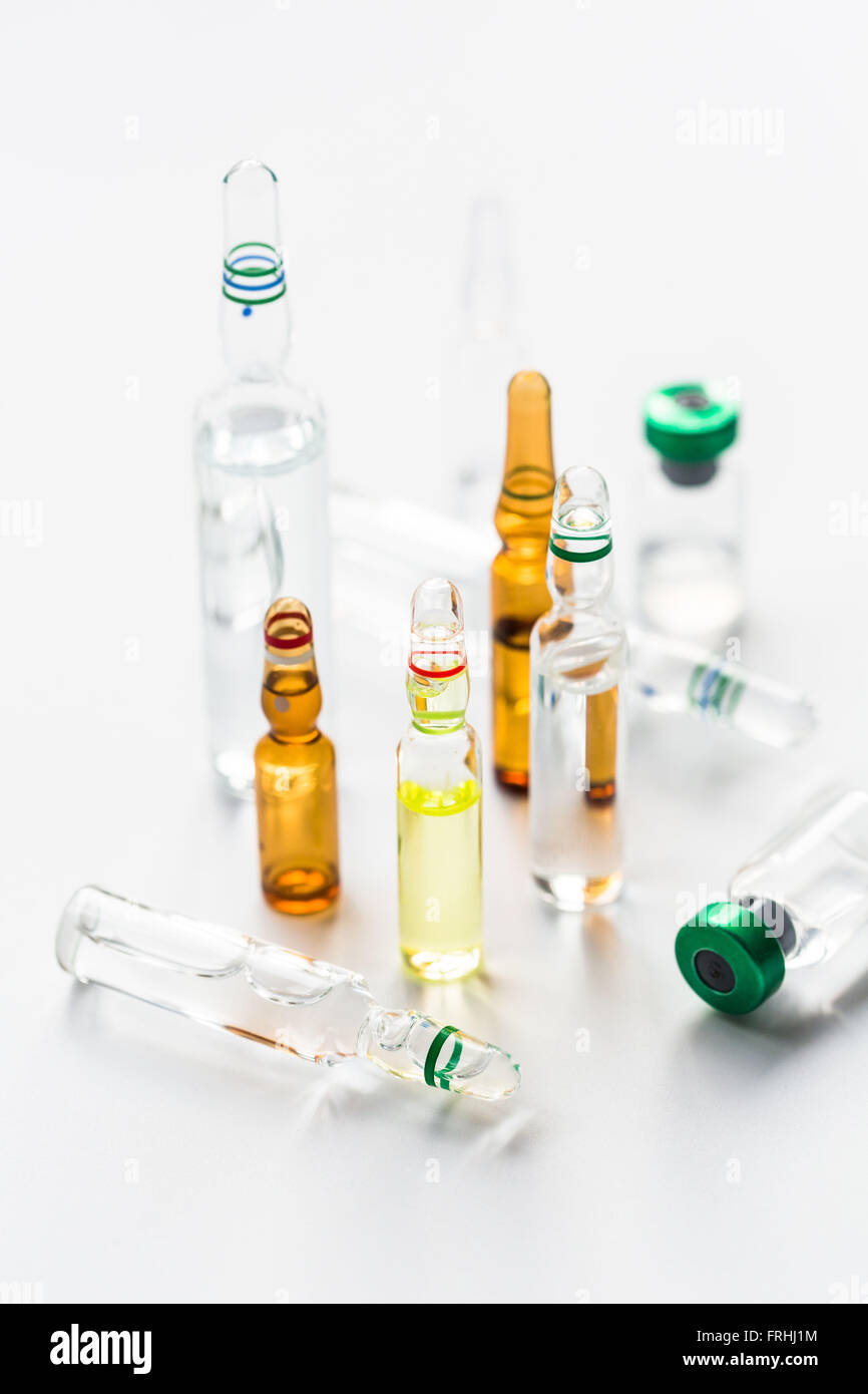 Ampoule containing a drug dose next to a syringe Stock Photo - Alamy