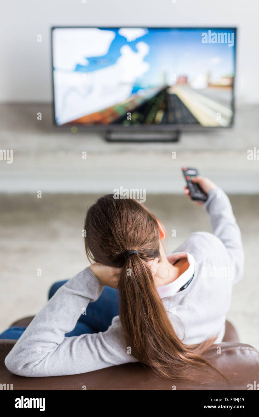 Woman watching TV Stock Photo - Alamy
