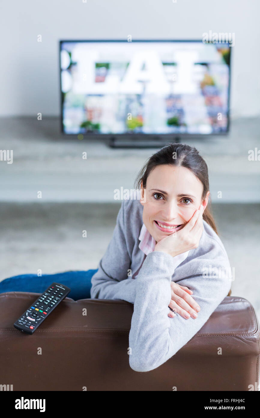 Woman watching TV Stock Photo - Alamy