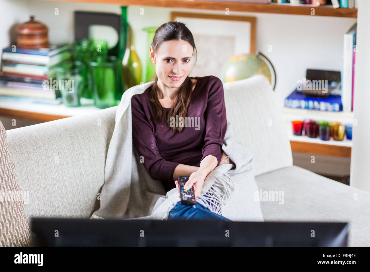 Woman watching TV Stock Photo - Alamy