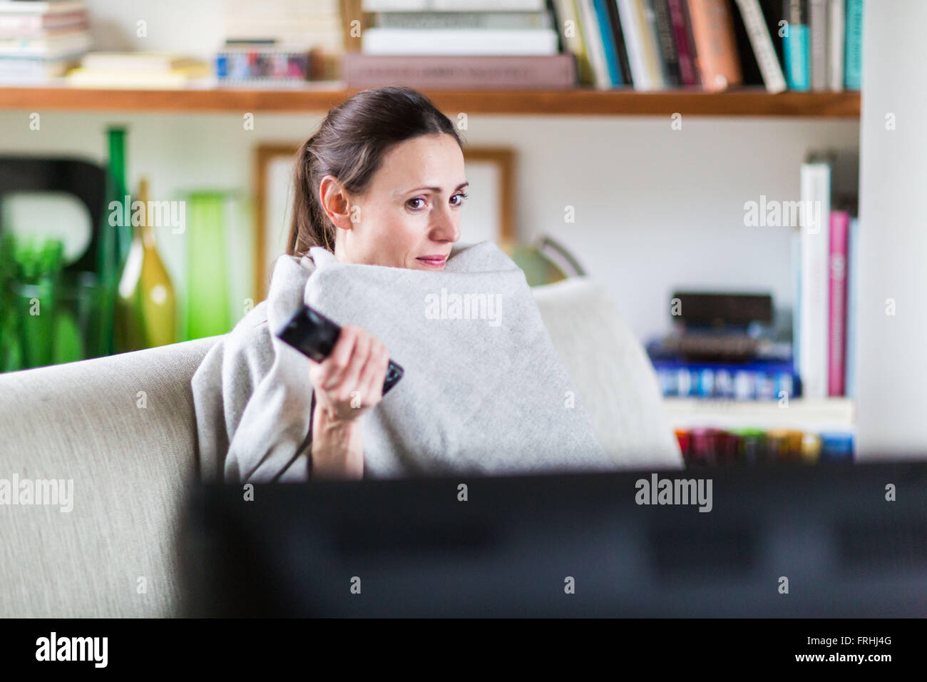 Woman watching TV Stock Photo - Alamy