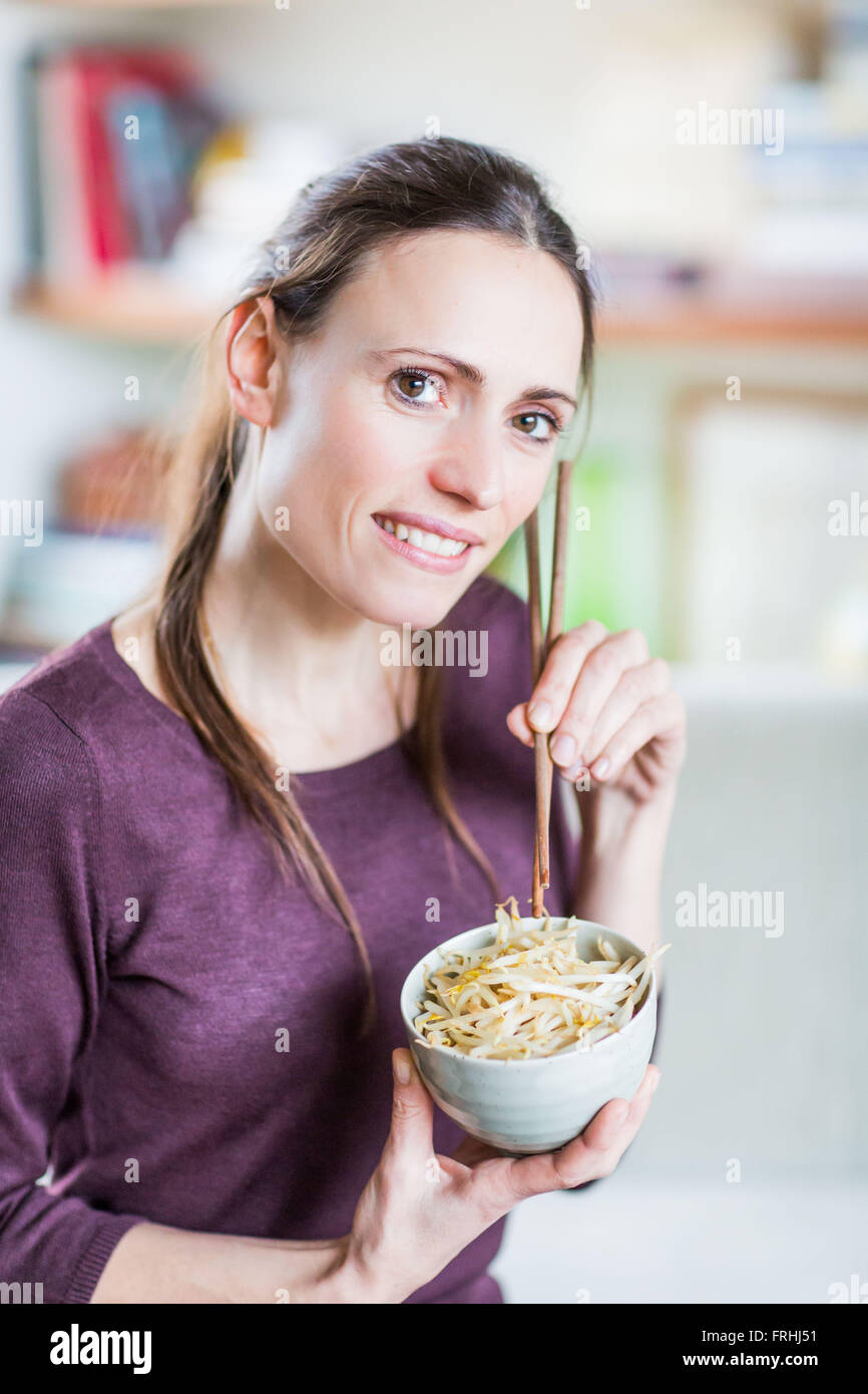 Woman eating a soybean sprouts Stock Photo - Alamy