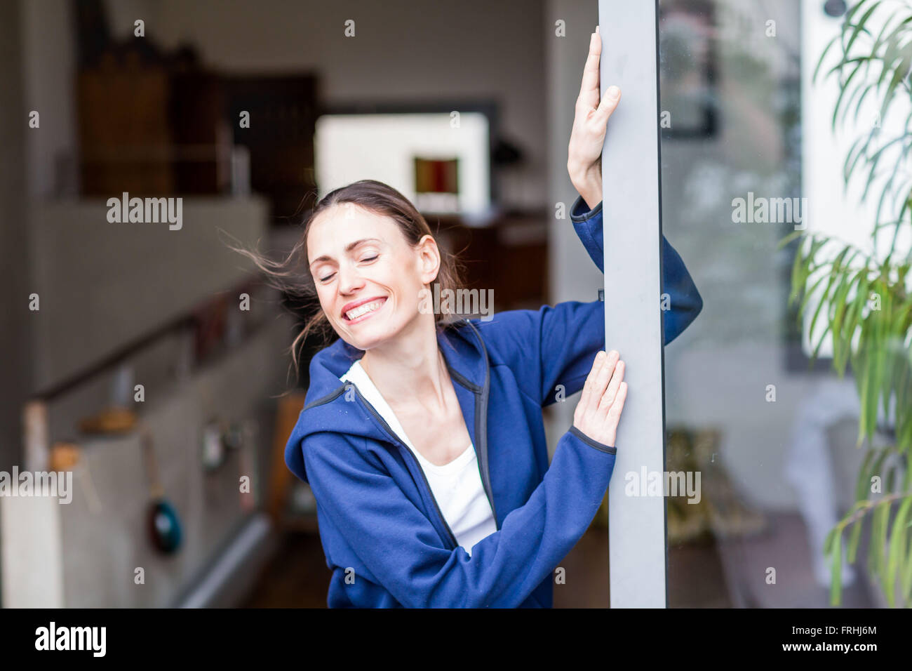 Woman opening window Stock Photo - Alamy