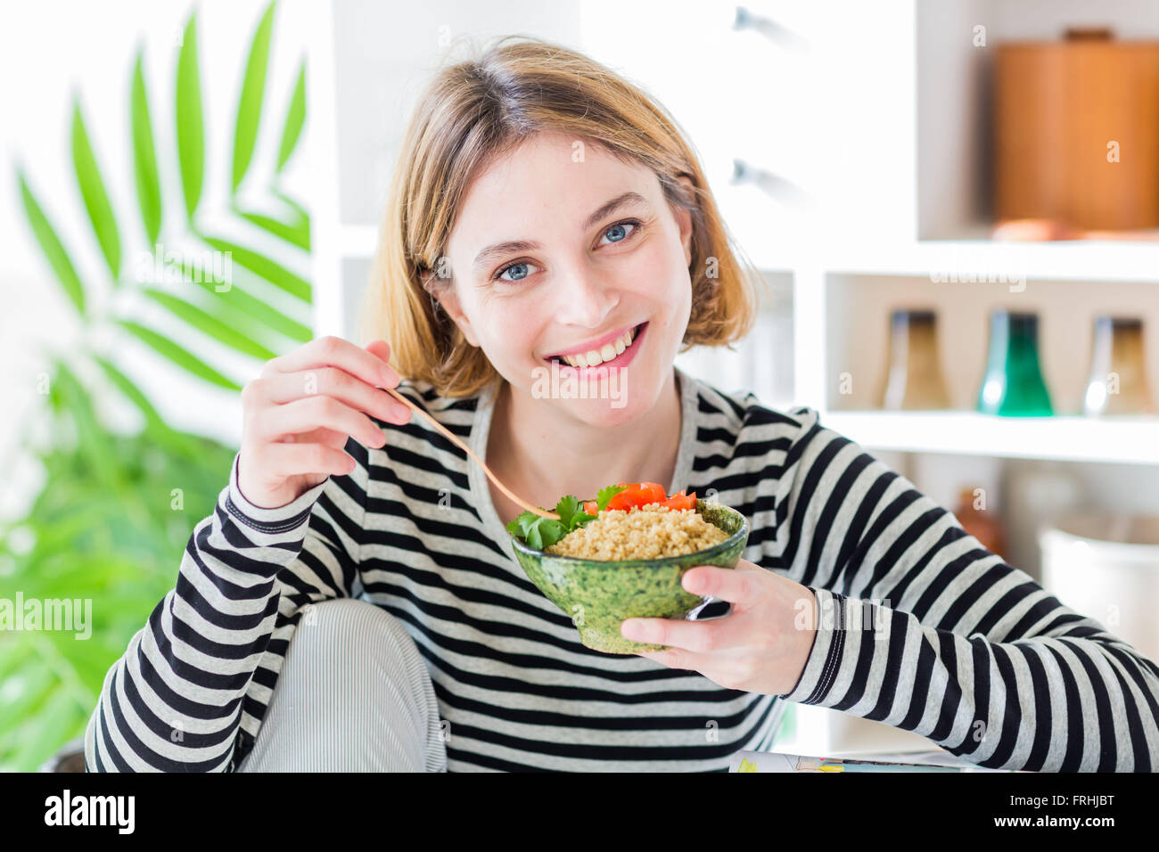 Woman eating a quinoa salad Stock Photo - Alamy