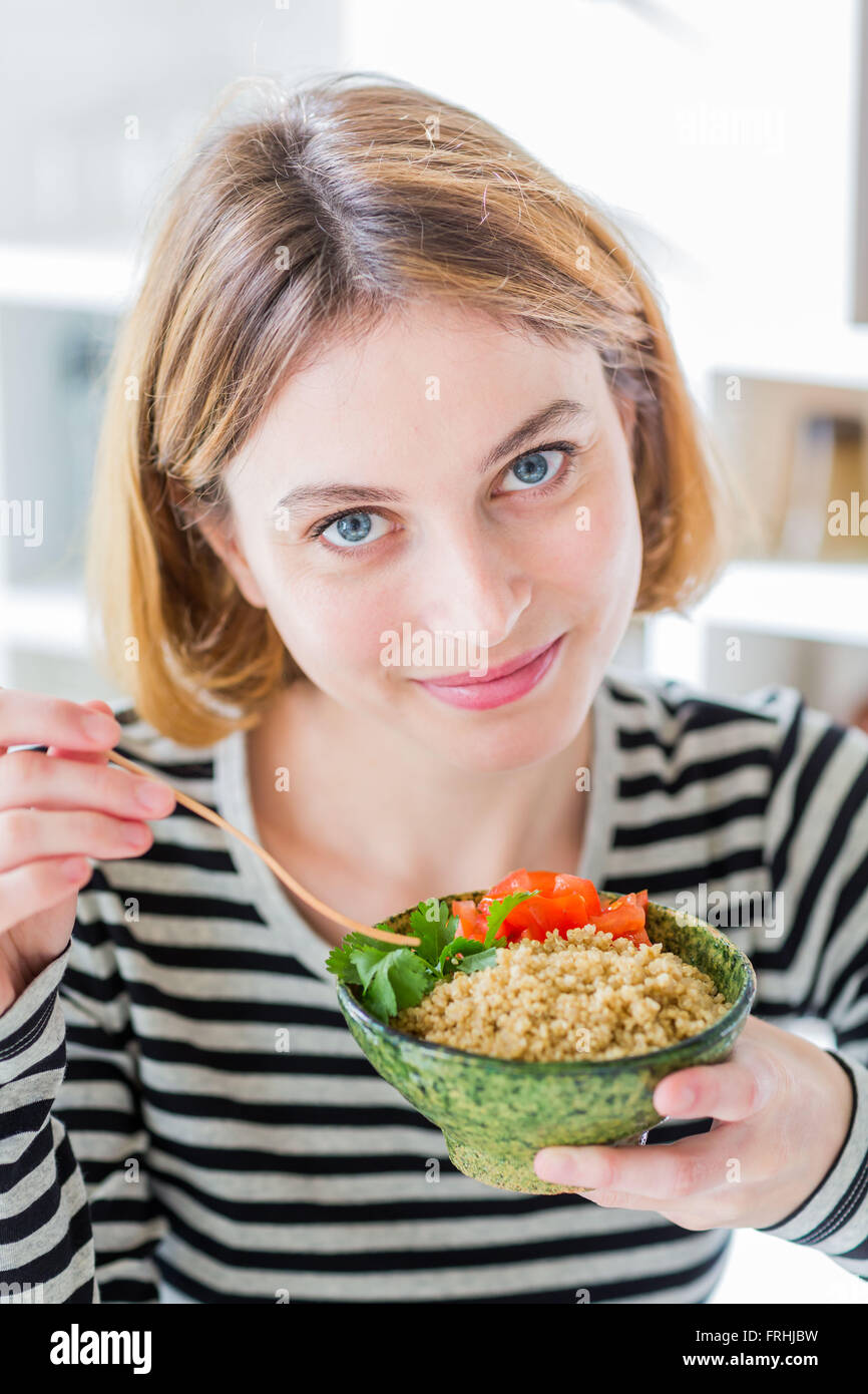 Woman eating a quinoa salad Stock Photo - Alamy