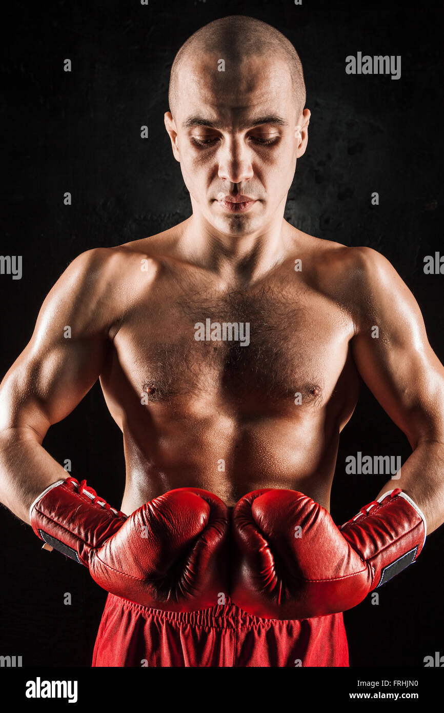 The young man kickboxing on black Stock Photo - Alamy