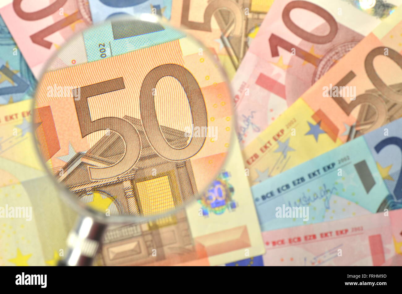 euro banknotes under magnifying glass Stock Photo - Alamy