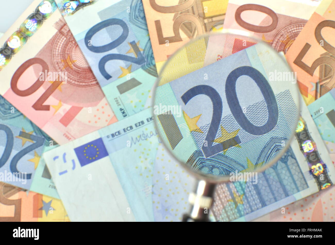 euro banknotes under magnifying glass Stock Photo - Alamy