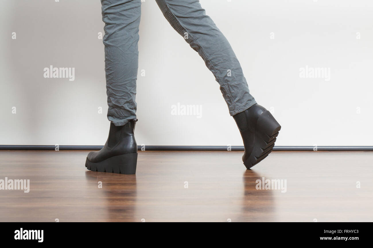 Young fashionable girl with long legs wearing black shoes on platform ...