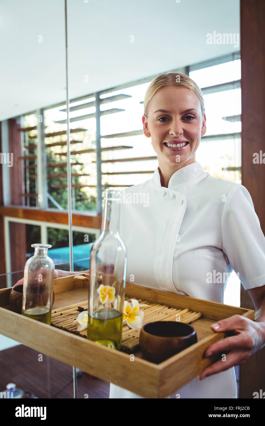 Smiling masseuse holding a tray Stock Photo - Alamy