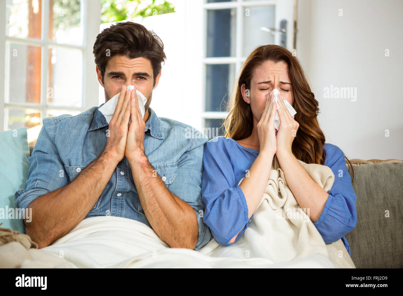 Woman blowing nose in room hi-res stock photography and images - Alamy