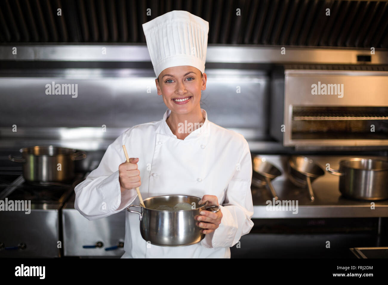 Portrait of happy female chef holding saucepan Stock Photo - Alamy