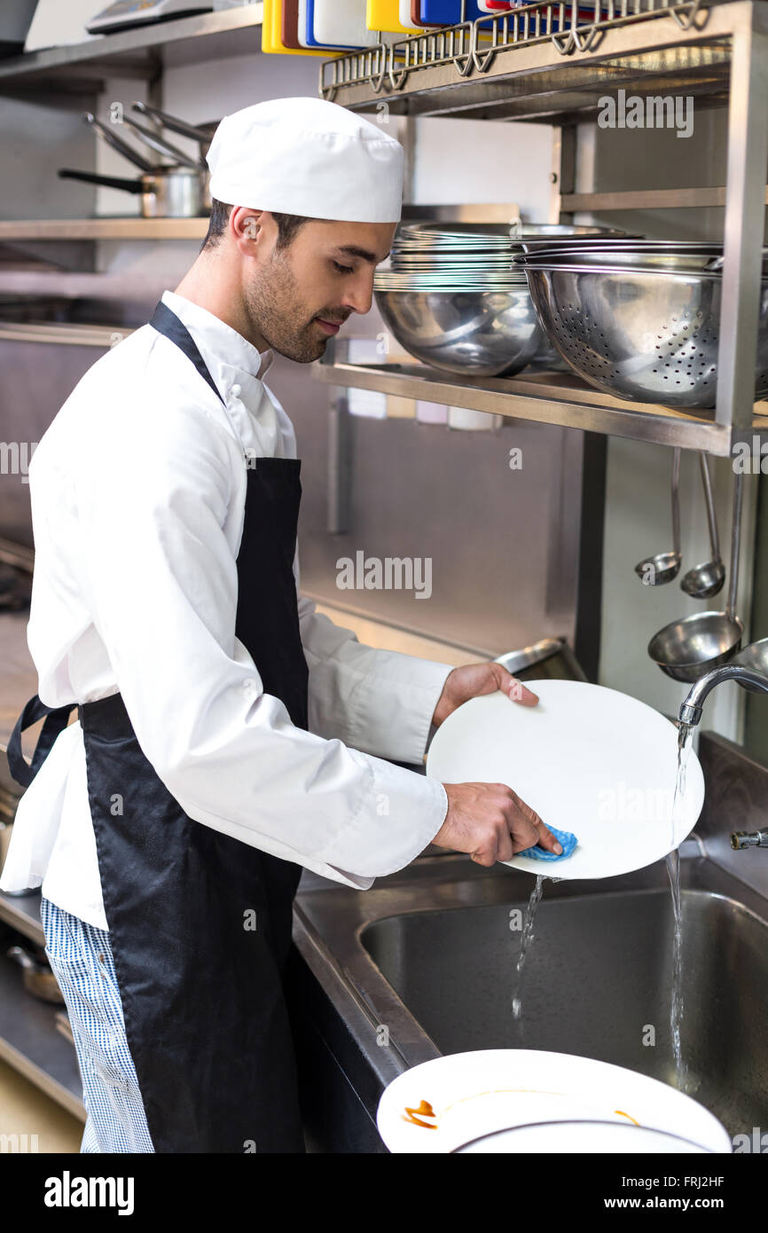 Handsome employee doing dishes Stock Photo - Alamy
