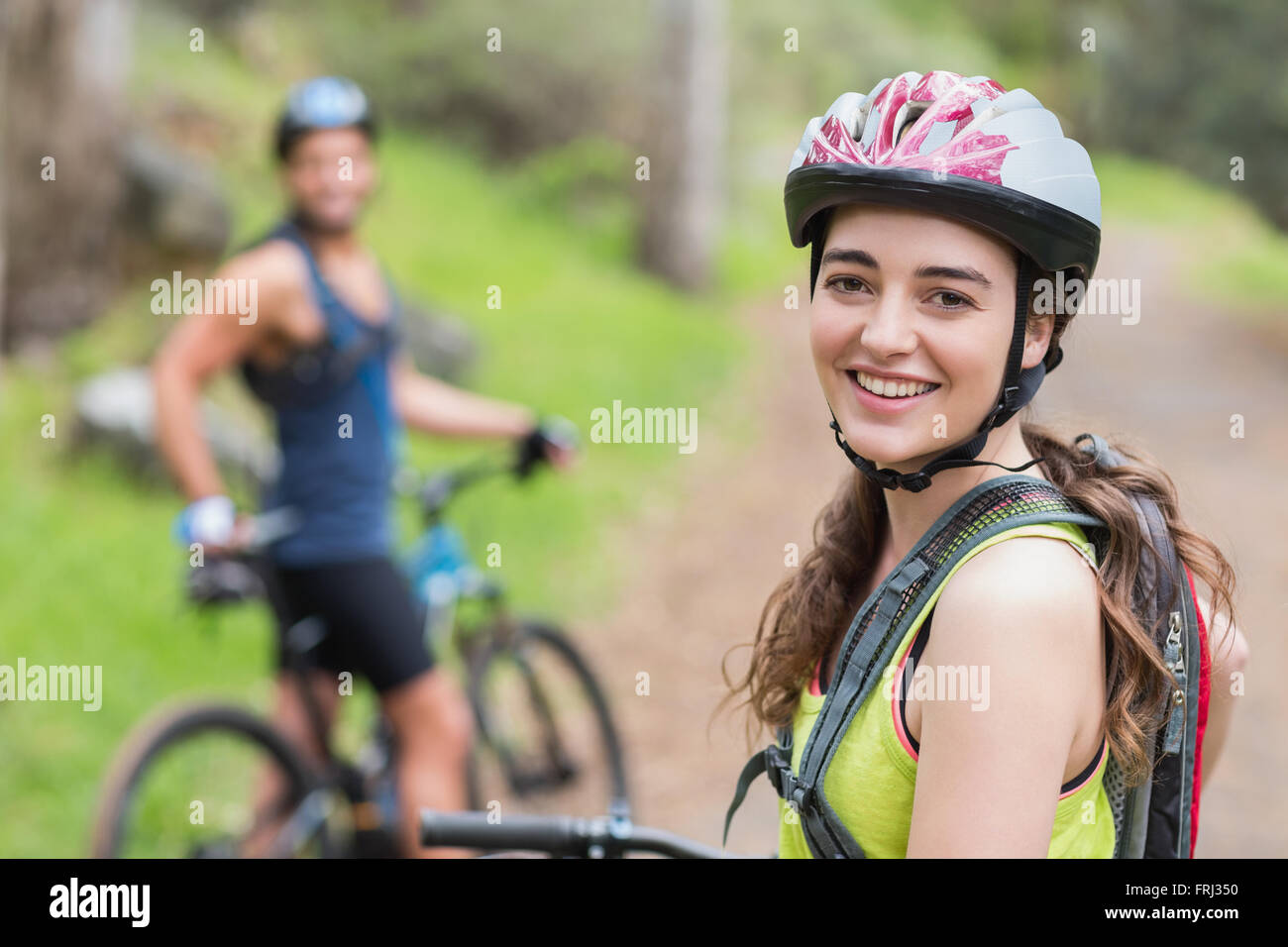 Portrait of confident female biker with man Stock Photo - Alamy
