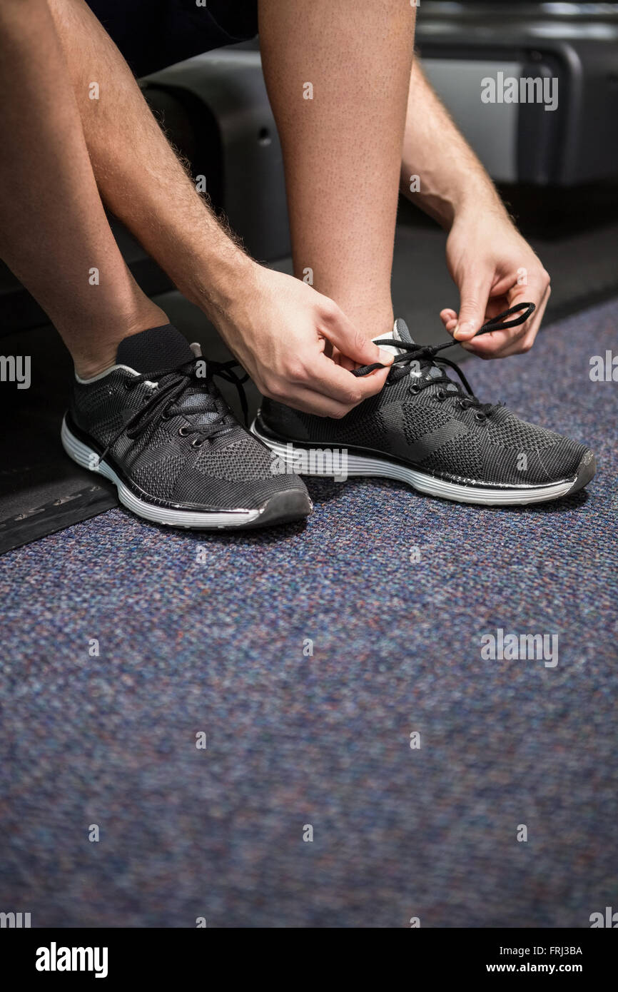Man tying up his shoe lace Stock Photo - Alamy