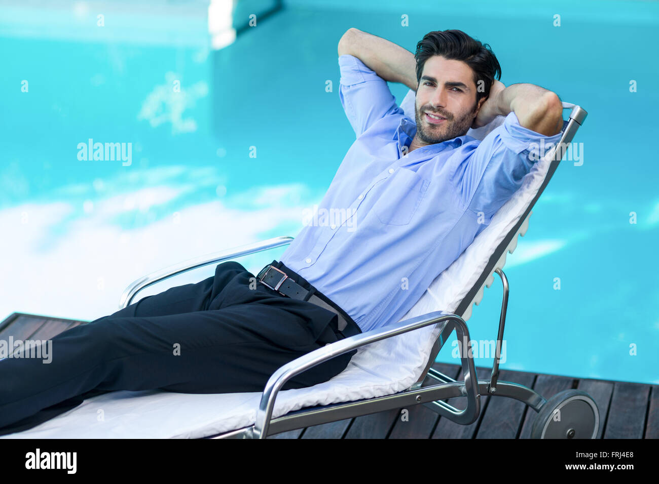 Smart man relaxing on sunlounger Stock Photo - Alamy