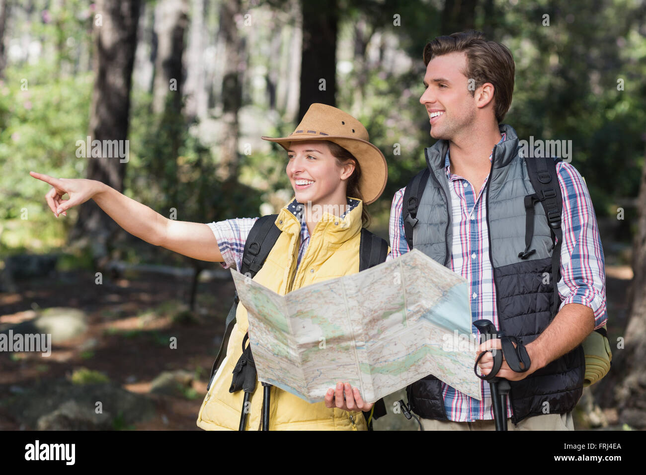 Woman pointing away with partner during hiking Stock Photo - Alamy
