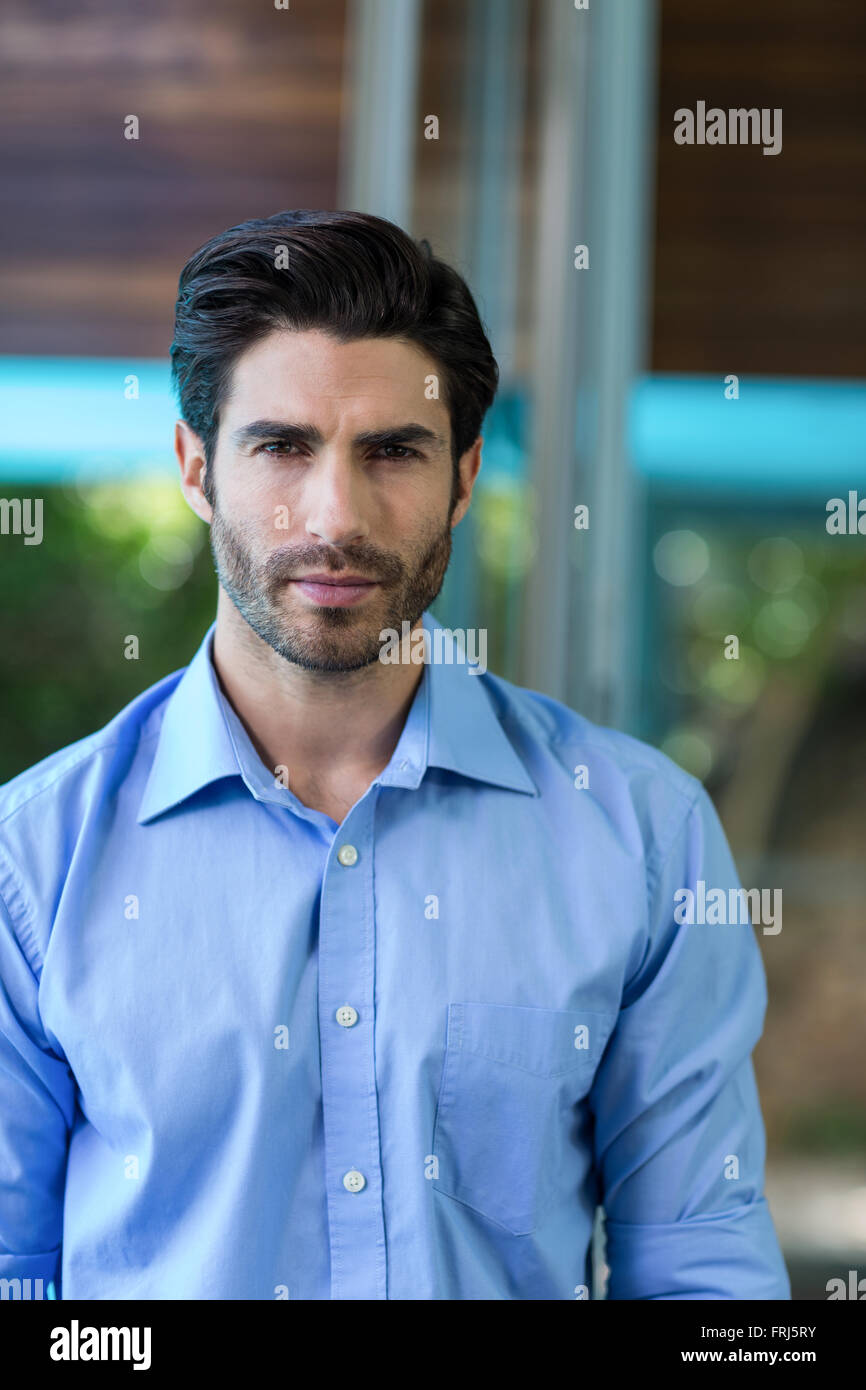 Serious smart man standing at resort Stock Photo - Alamy