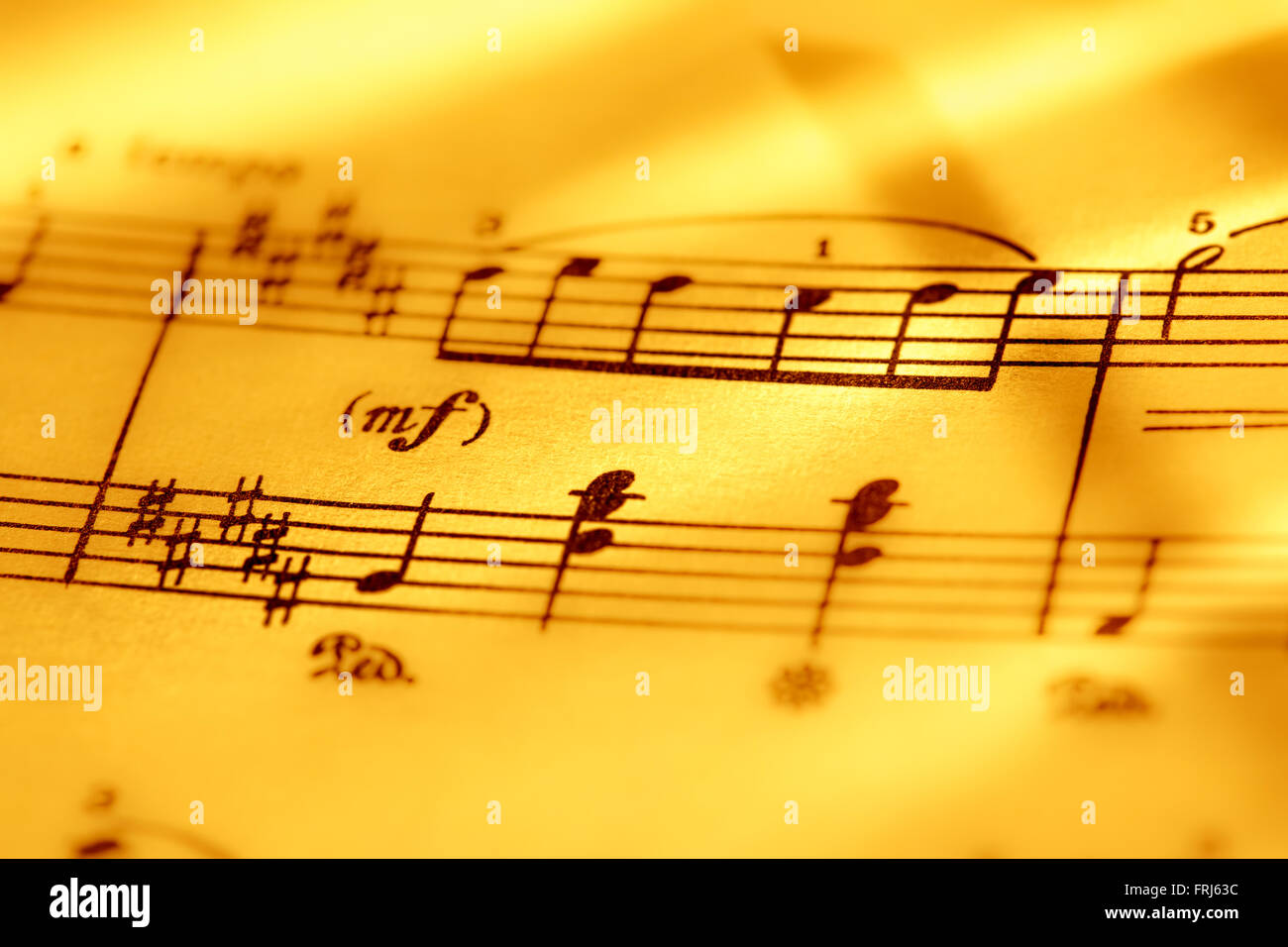Music notes in yellow toning in closeup Stock Photo - Alamy