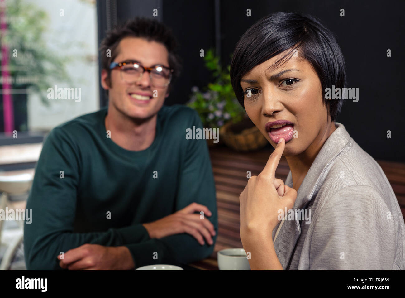 Disgusted woman speaking with man Stock Photo - Alamy
