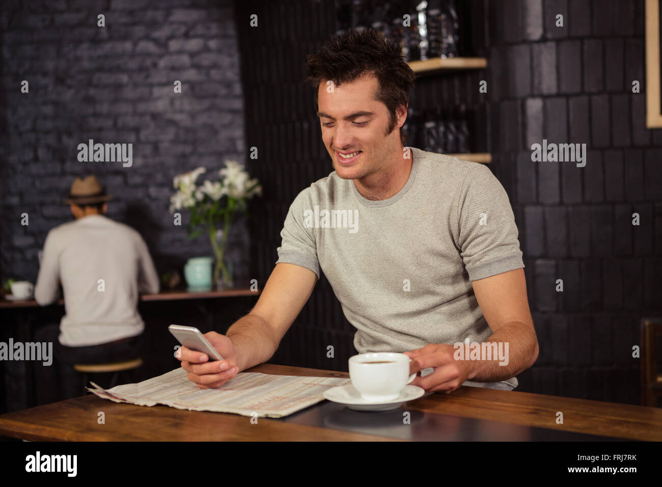 Man using his smartphone and drinking coffee Stock Photo - Alamy