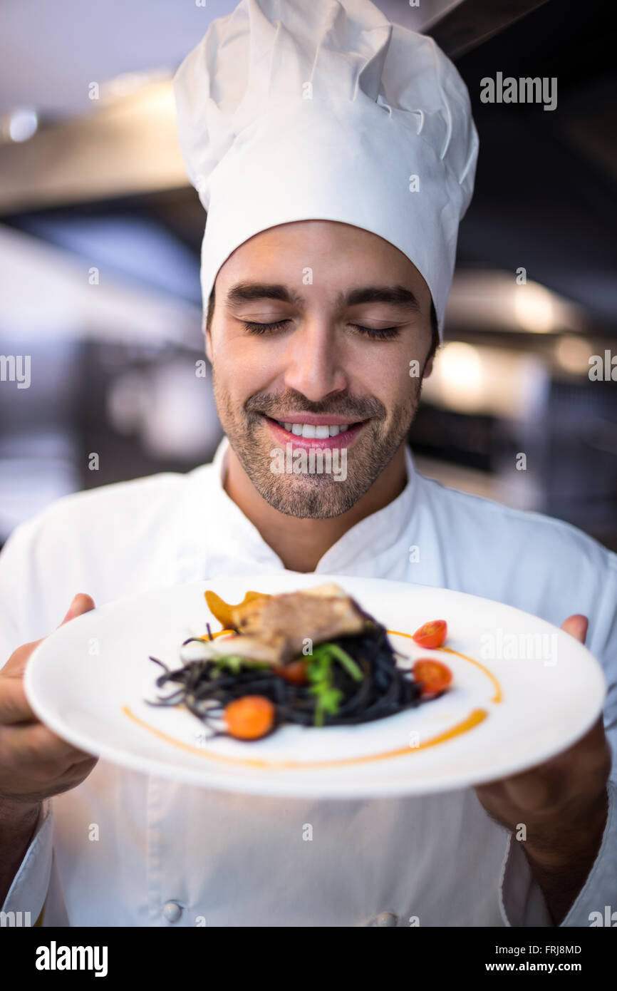 Handsome chef presenting meal Stock Photo - Alamy