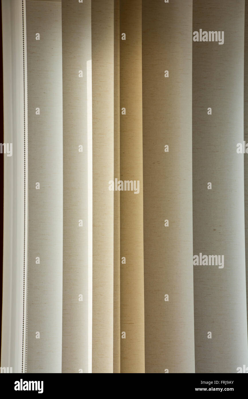 Sun shining through vertical blinds Stock Photo - Alamy