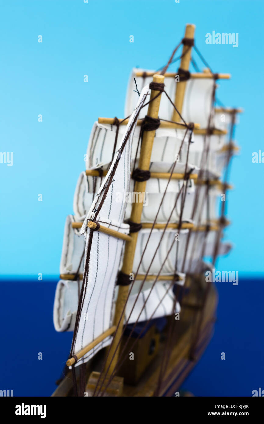 Wooden handmade ship on blue background Stock Photo - Alamy