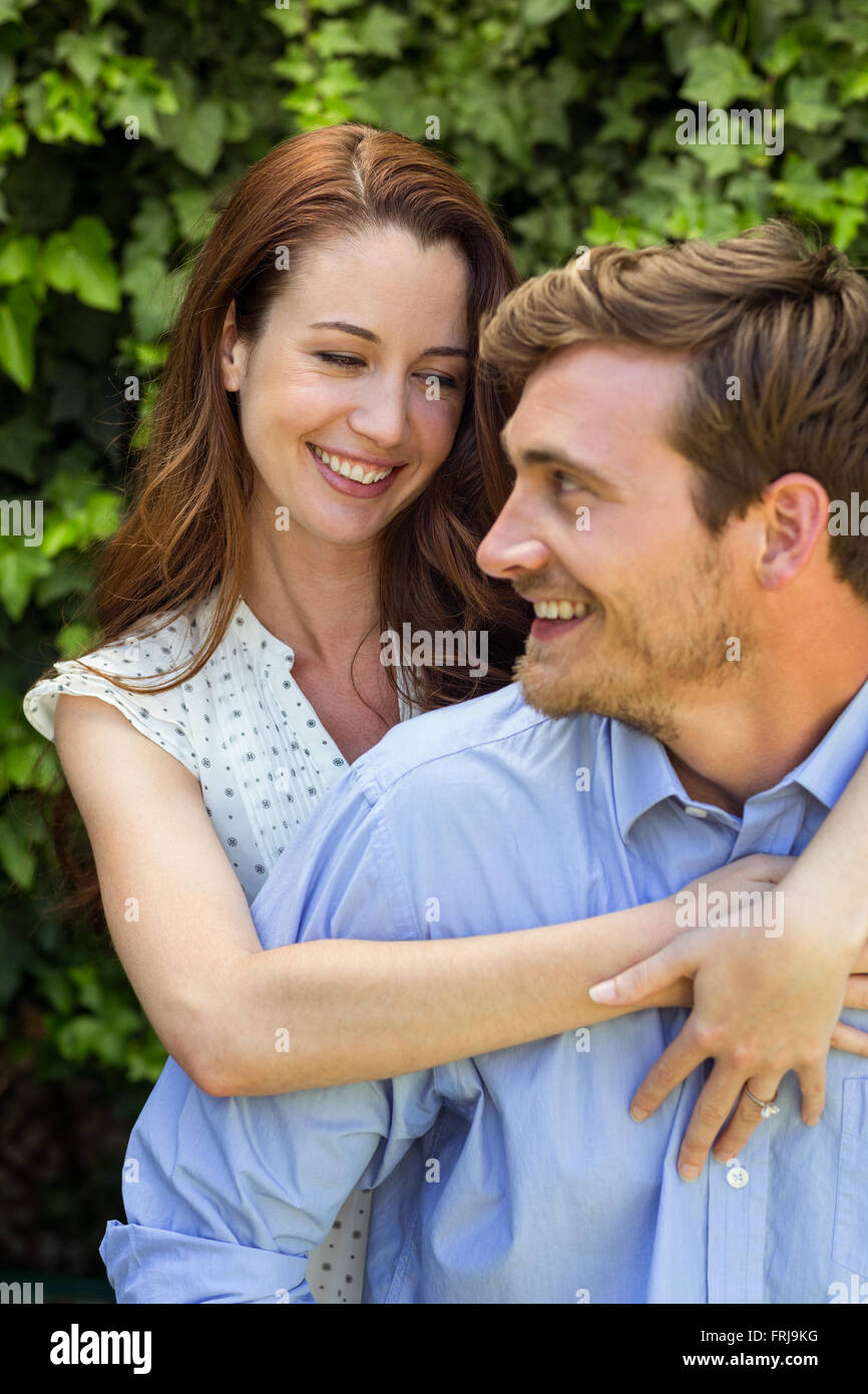 Young couple hugging at front yard Stock Photo - Alamy