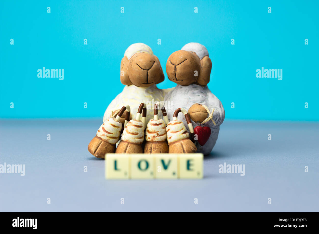 Ceramic sheep with love sign on blue background Stock Photo - Alamy