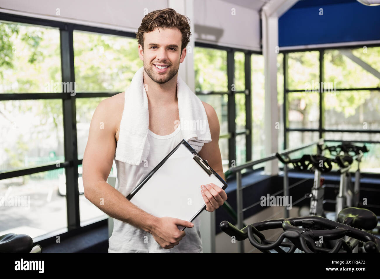 Gym instructor holding clipboard Stock Photo - Alamy