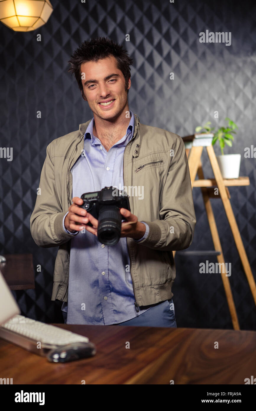Creative businessman looking at picture on camera Stock Photo - Alamy