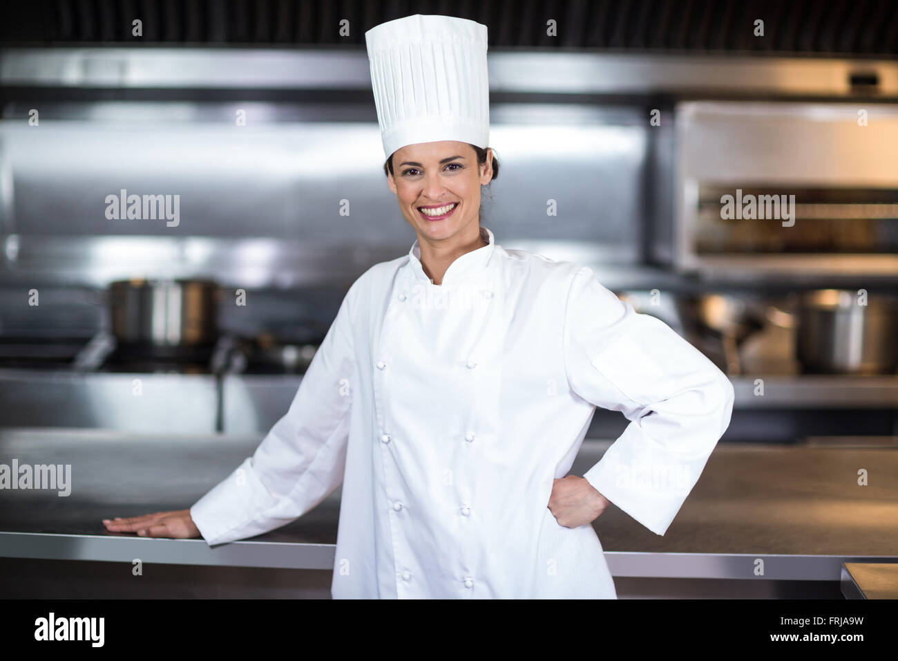 Portrait of happy female chef in kitchen Stock Photo - Alamy