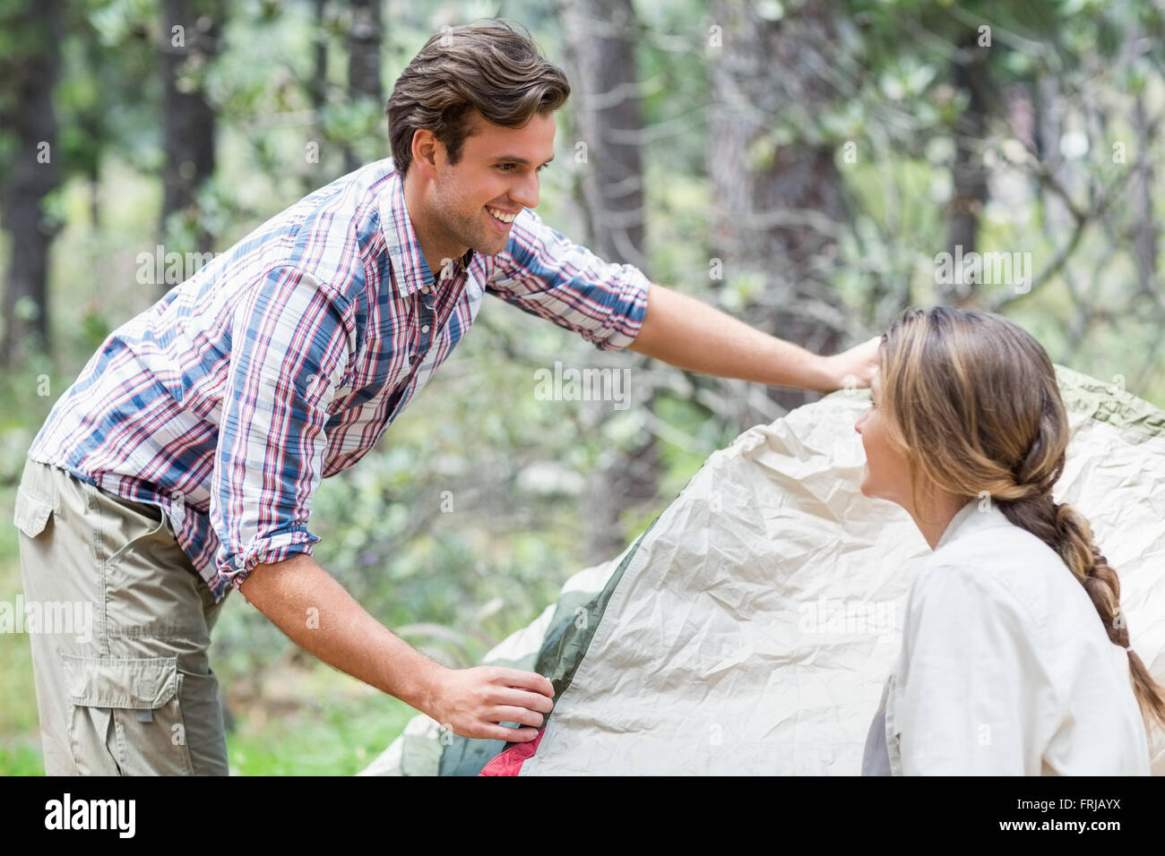 Couple looking face to face while camping Stock Photo - Alamy