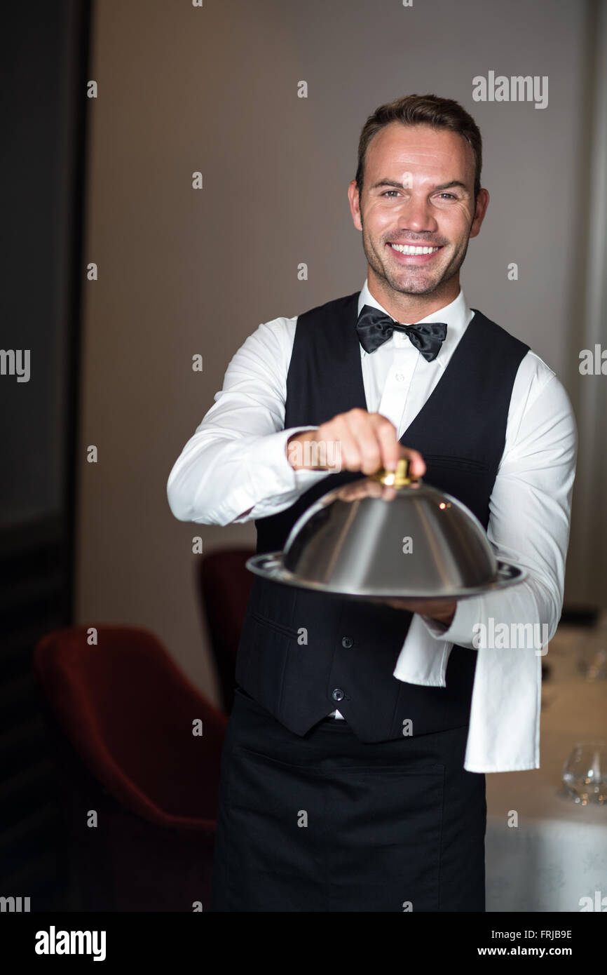 Handsome waiter holding tray Stock Photo - Alamy