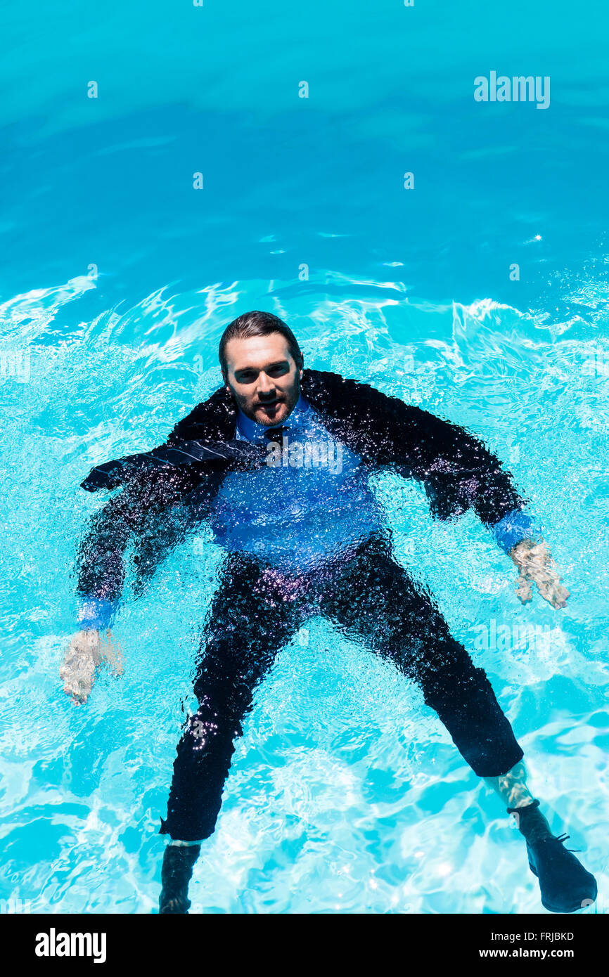Dressed businessman in swimming pool Stock Photo - Alamy