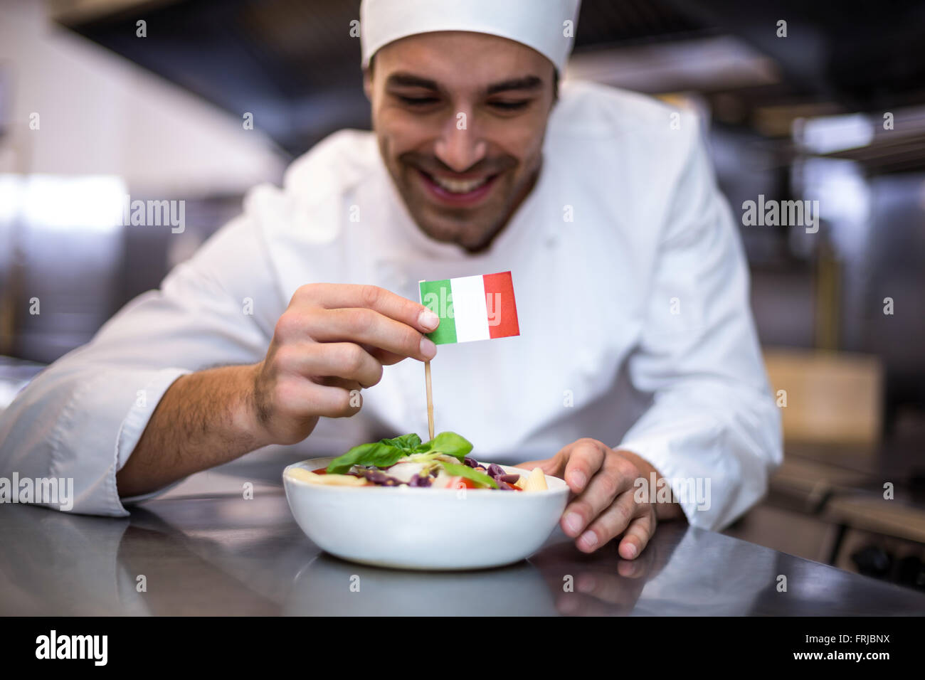 Handsome chef presenting meal with italian flag Stock Photo - Alamy